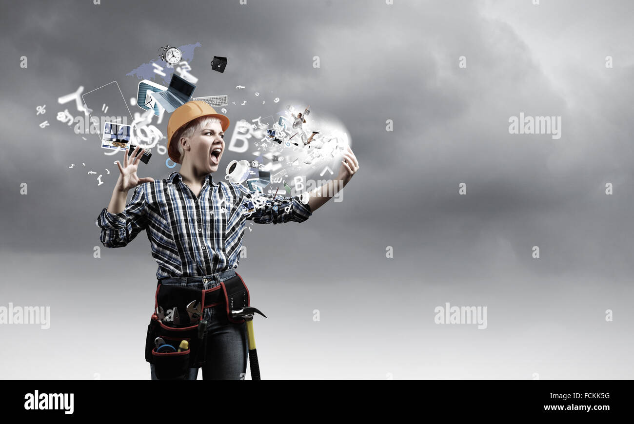 Young emotional woman mechanic screaming in mobile phone Stock Photo ...