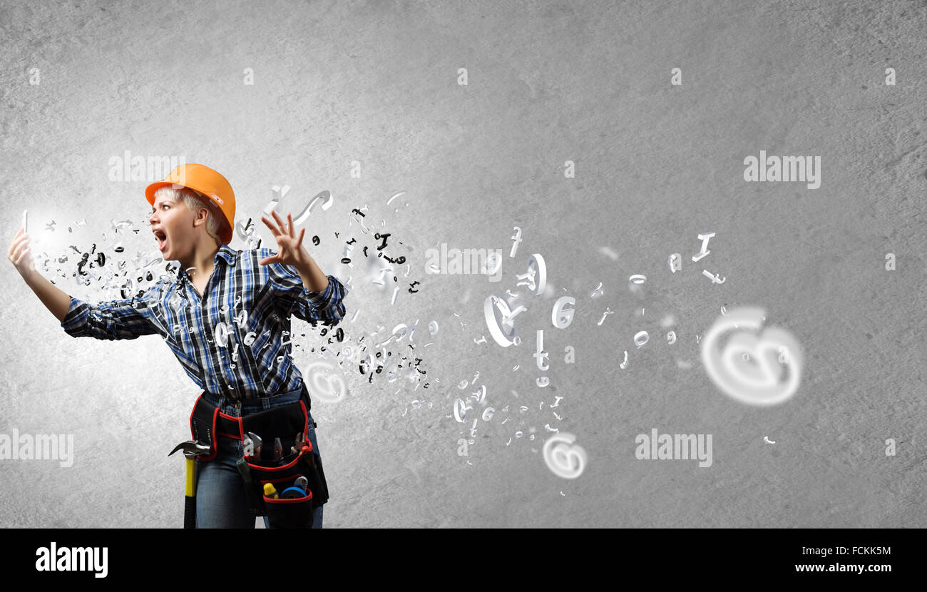 Young emotional woman mechanic screaming in mobile phone Stock Photo ...