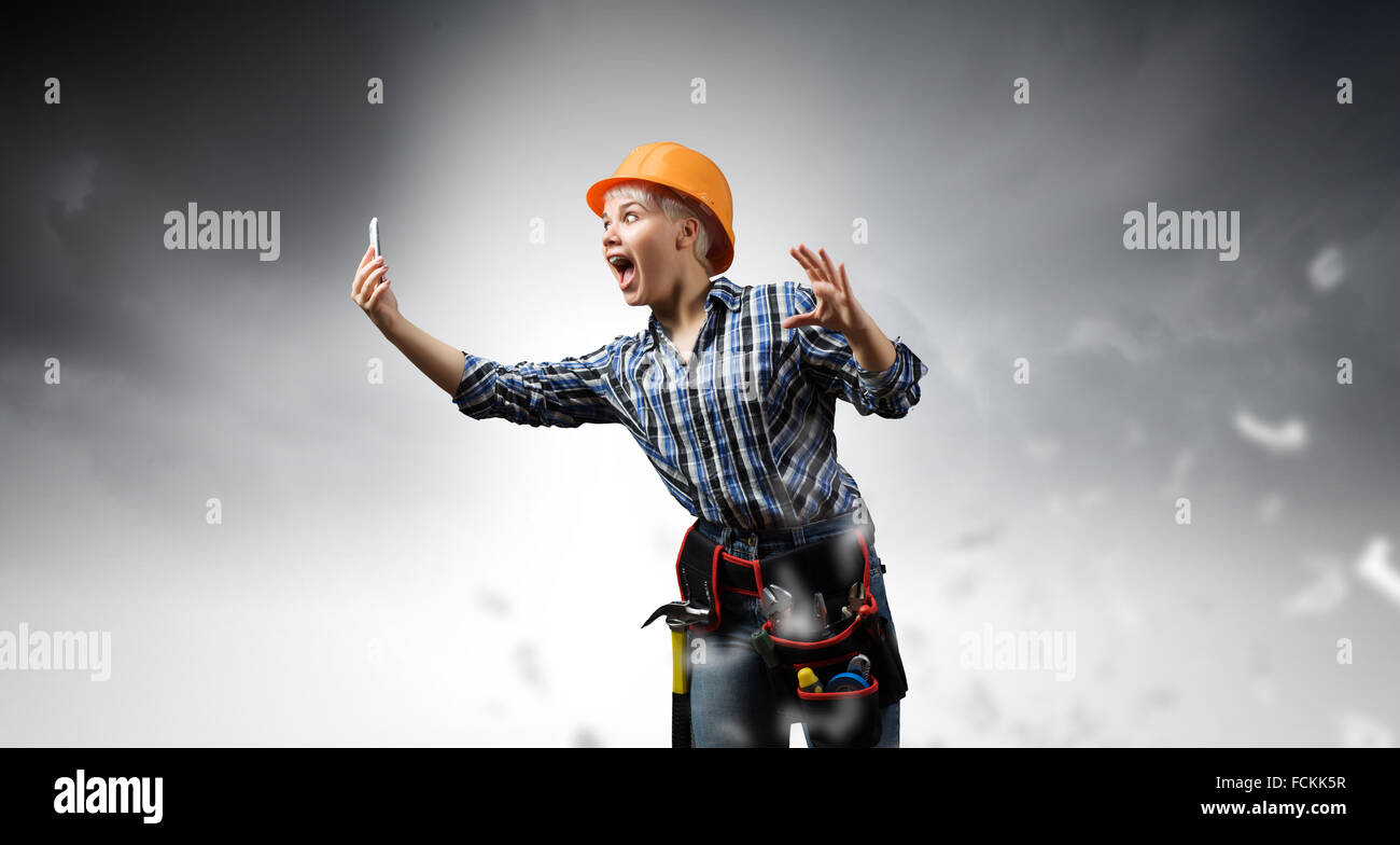 Young emotional woman mechanic screaming in mobile phone Stock Photo ...