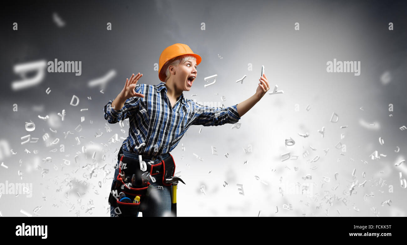 Young emotional woman mechanic screaming in mobile phone Stock Photo ...