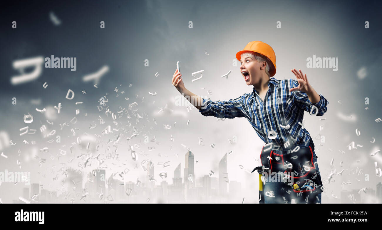 Young emotional woman mechanic screaming in mobile phone Stock Photo ...