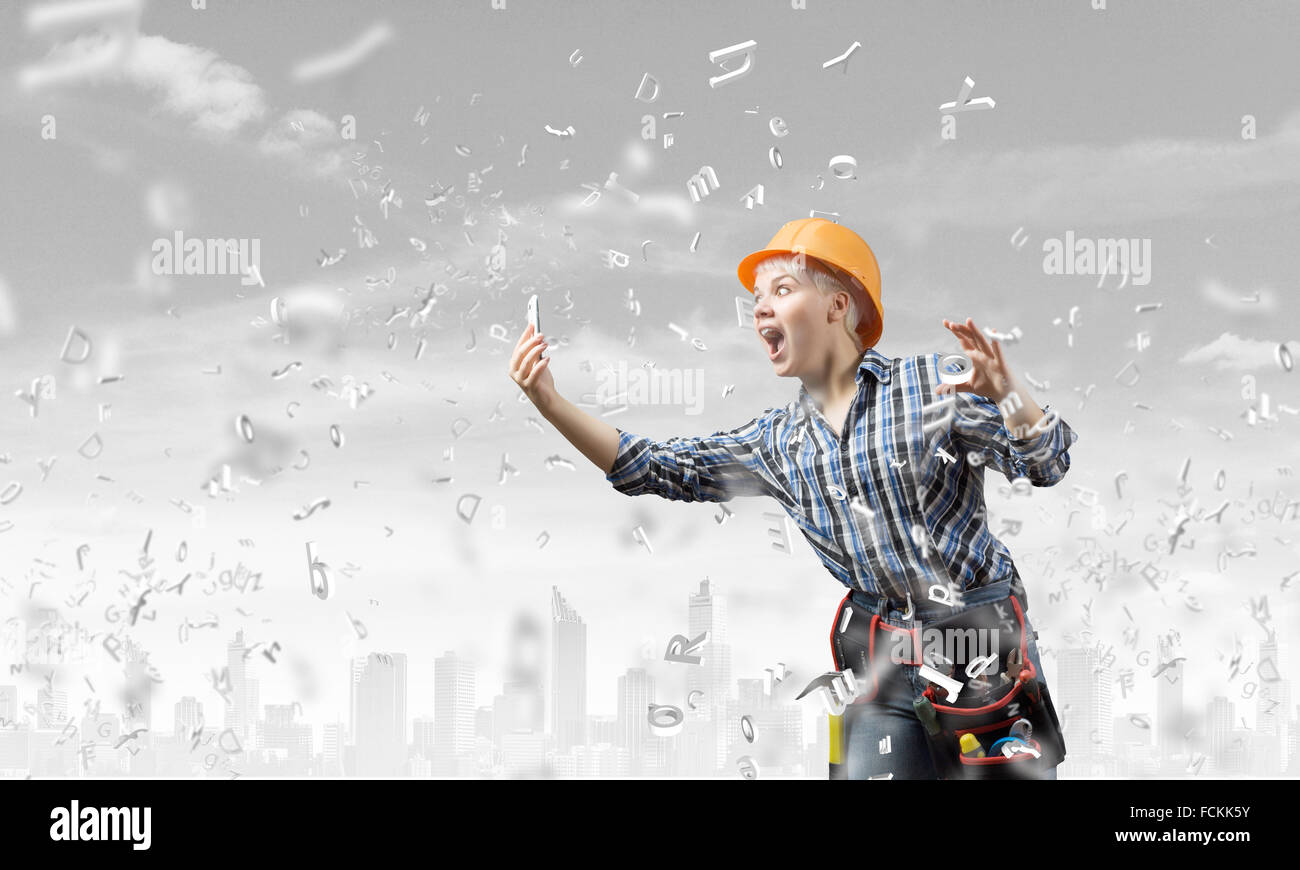 Young emotional woman mechanic screaming in mobile phone Stock Photo ...