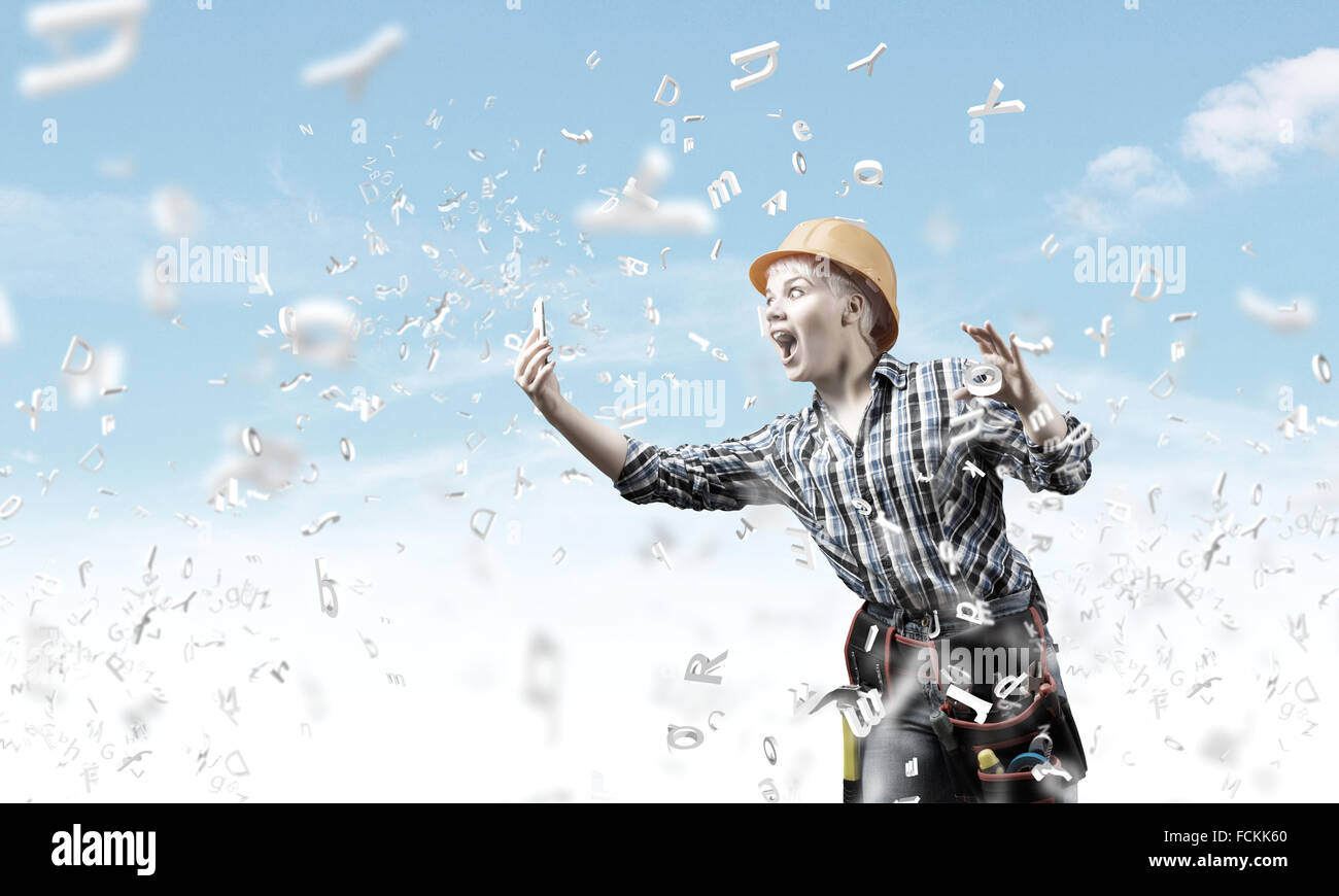 Young emotional woman mechanic screaming in mobile phone Stock Photo ...