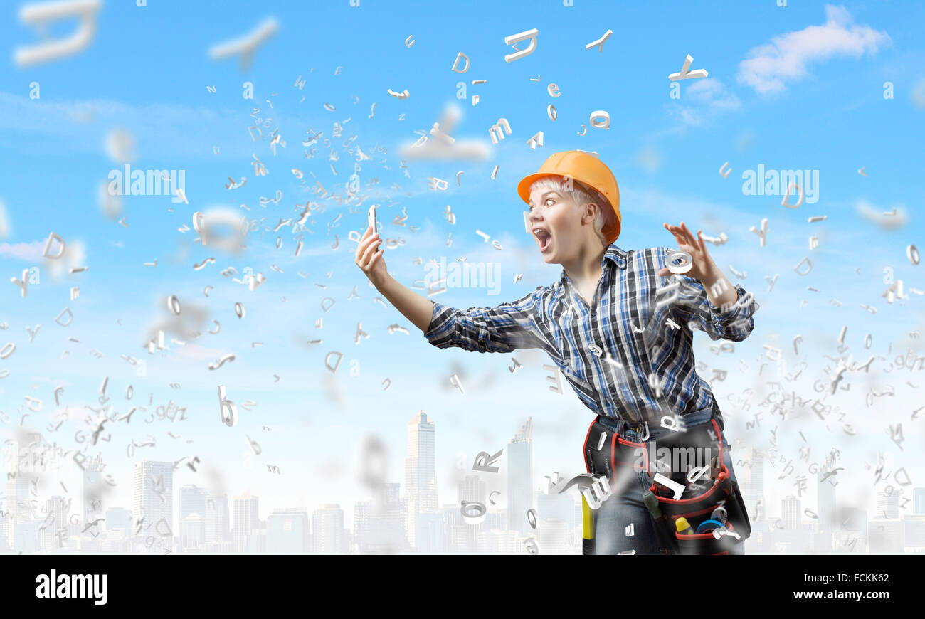 Young emotional woman mechanic screaming in mobile phone Stock Photo ...