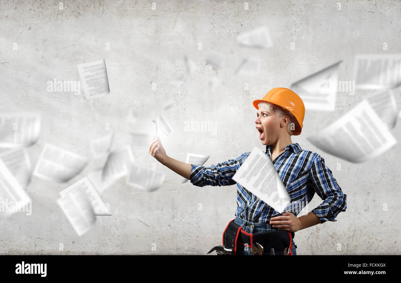 Young emotional woman mechanic screaming in mobile phone Stock Photo ...