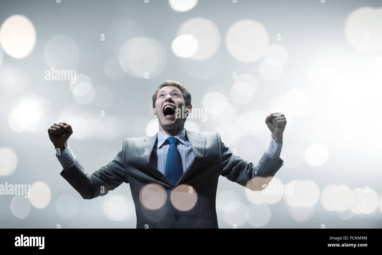 Young handsome businessman with hands up celebrating success Stock ...