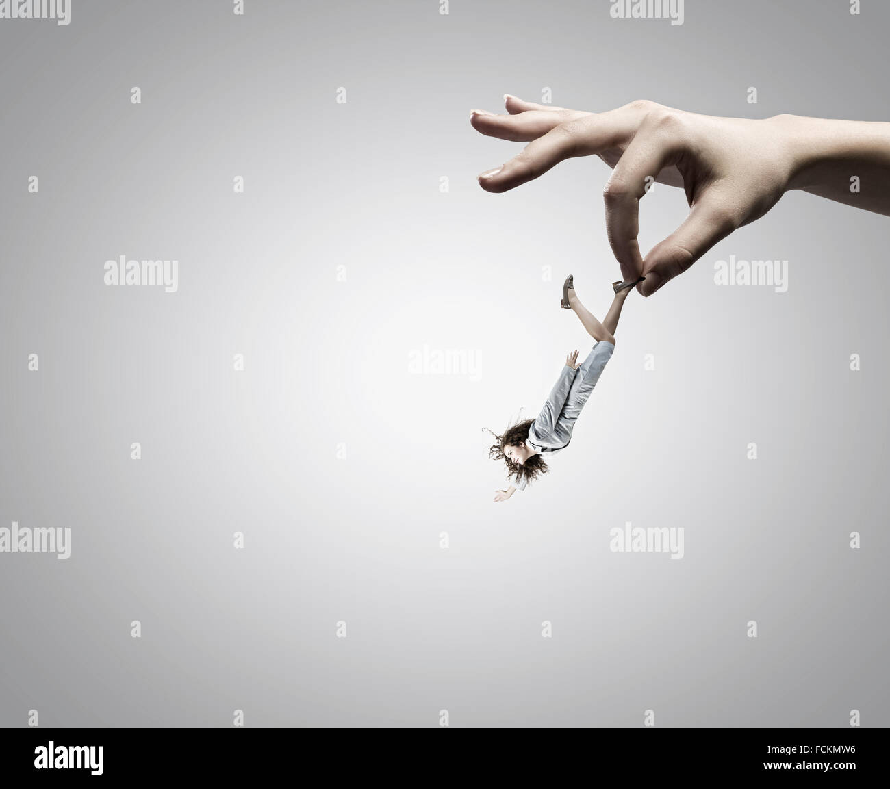 Giant human hand holding miniature of businesswoman Stock Photo - Alamy