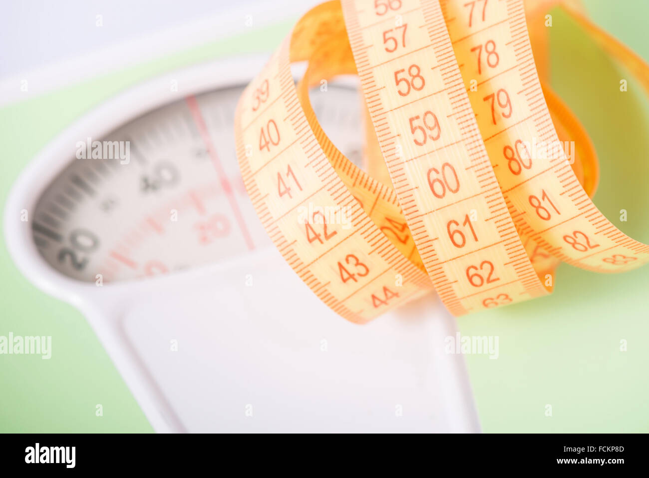 Measuring tape on top of scales Stock Photo - Alamy