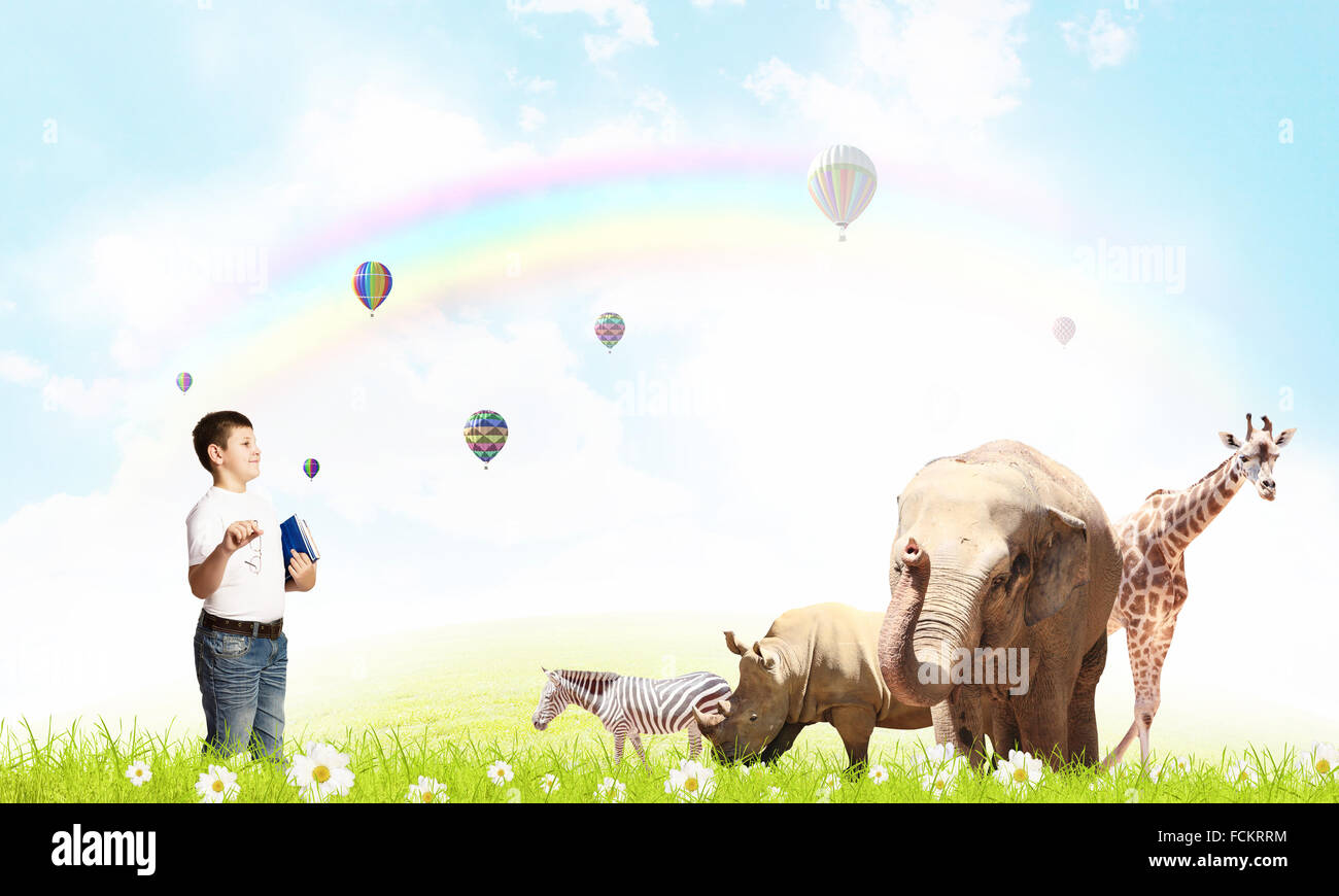 Boy of school age outdoor with wild animals Stock Photo - Alamy