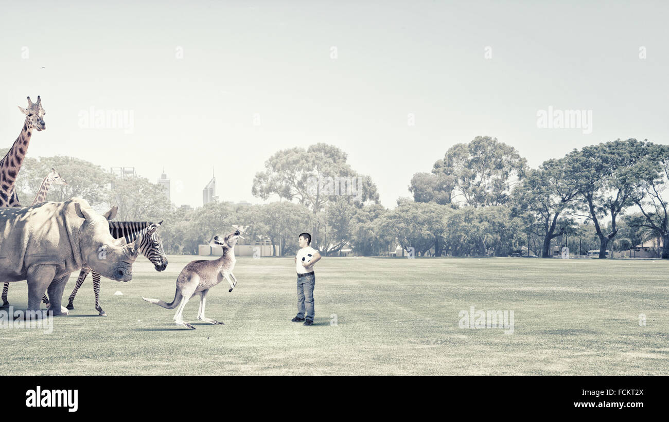 Boy of school age outdoor with wild animals Stock Photo - Alamy