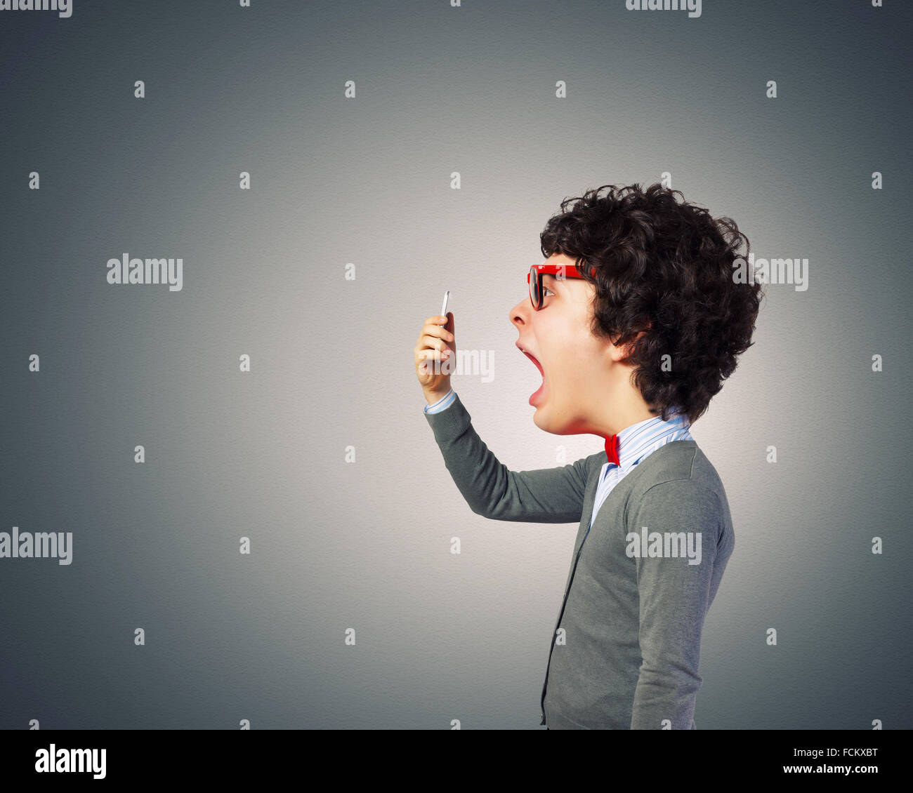 Funny young man with big head screaming emotional in mobile phone Stock ...