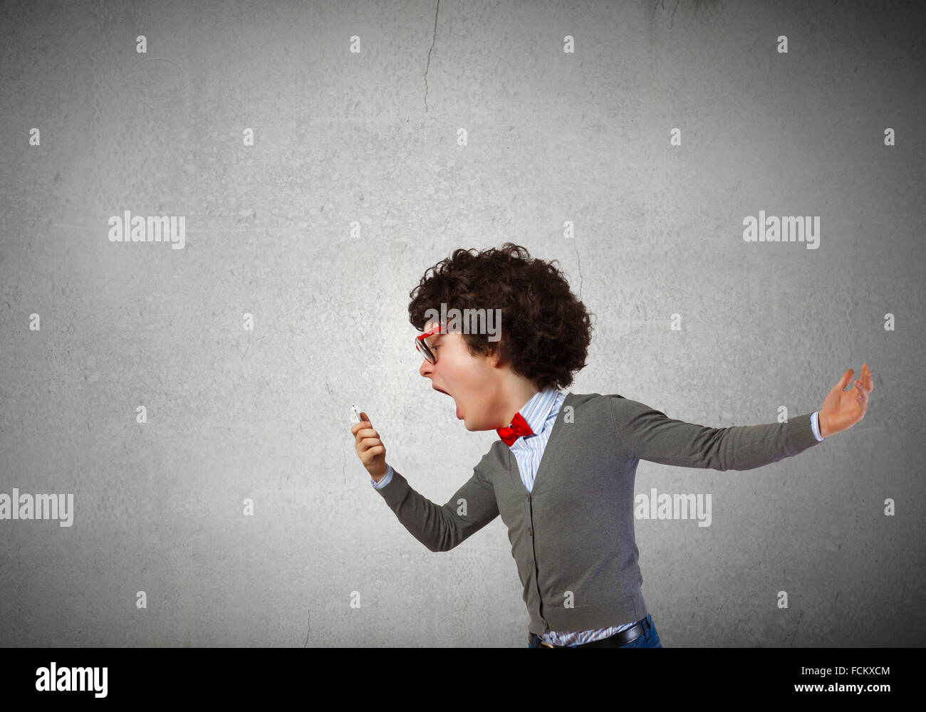 Funny young man with big head screaming emotional in mobile phone Stock ...