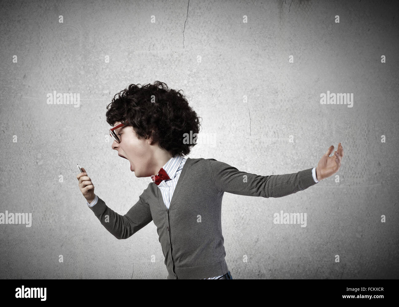 Funny young man with big head screaming emotional in mobile phone Stock ...