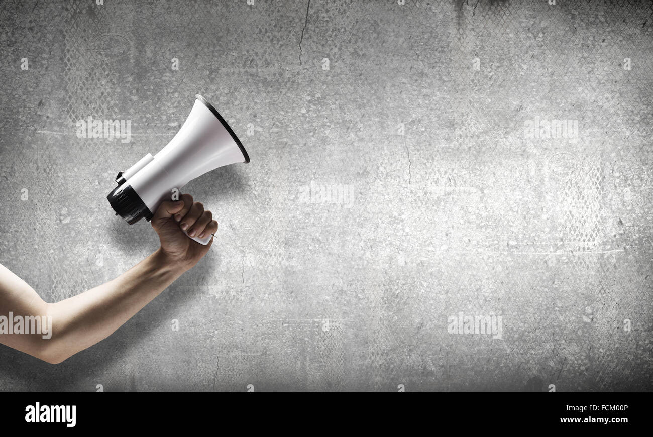 Close up of human hand holding megaphone Stock Photo - Alamy