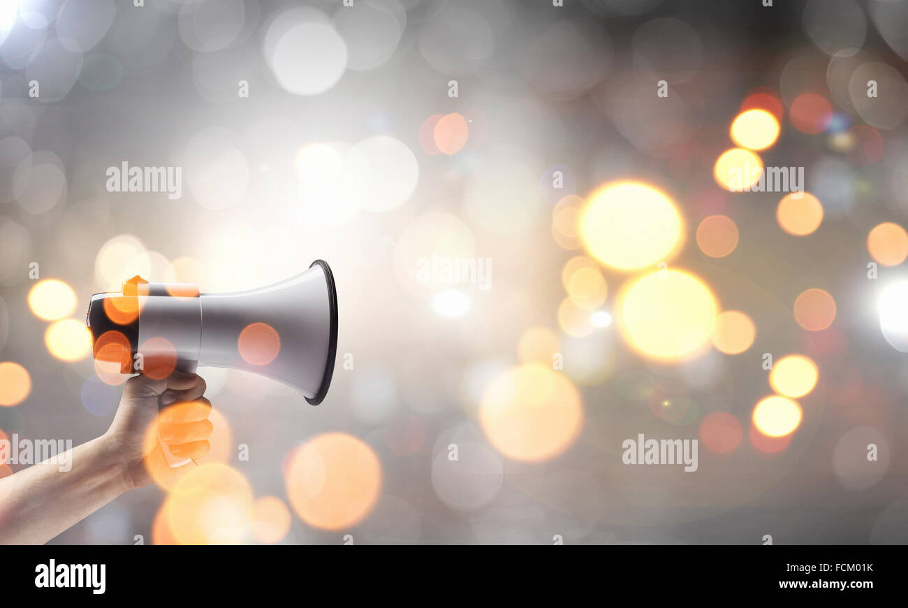 Close up of human hand holding megaphone Stock Photo - Alamy