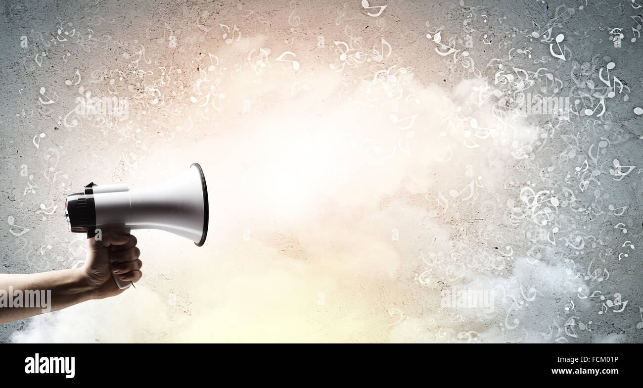 Close up of human hand holding megaphone Stock Photo - Alamy