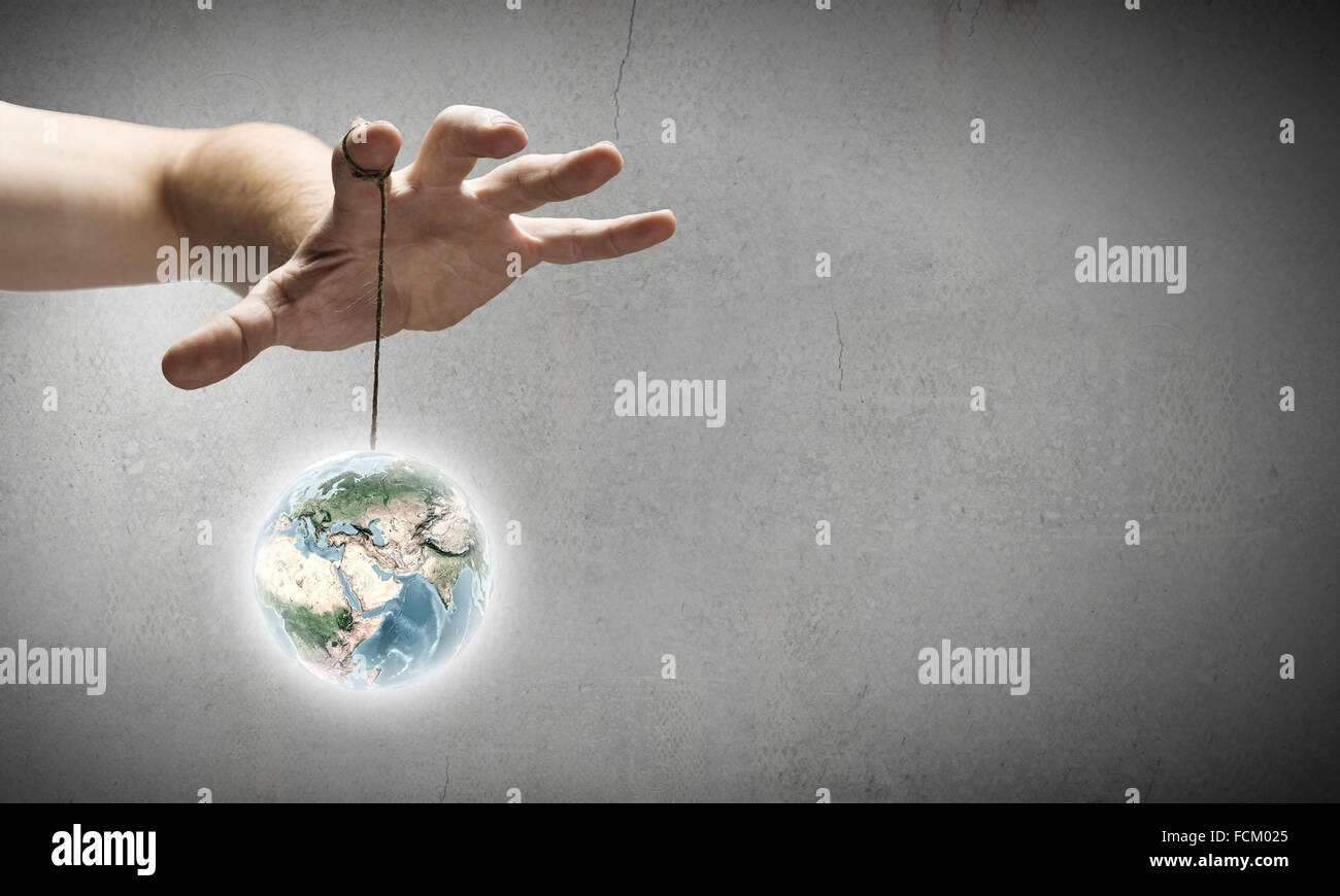Close up of human hand and items hanging on fingers. Elements of this ...
