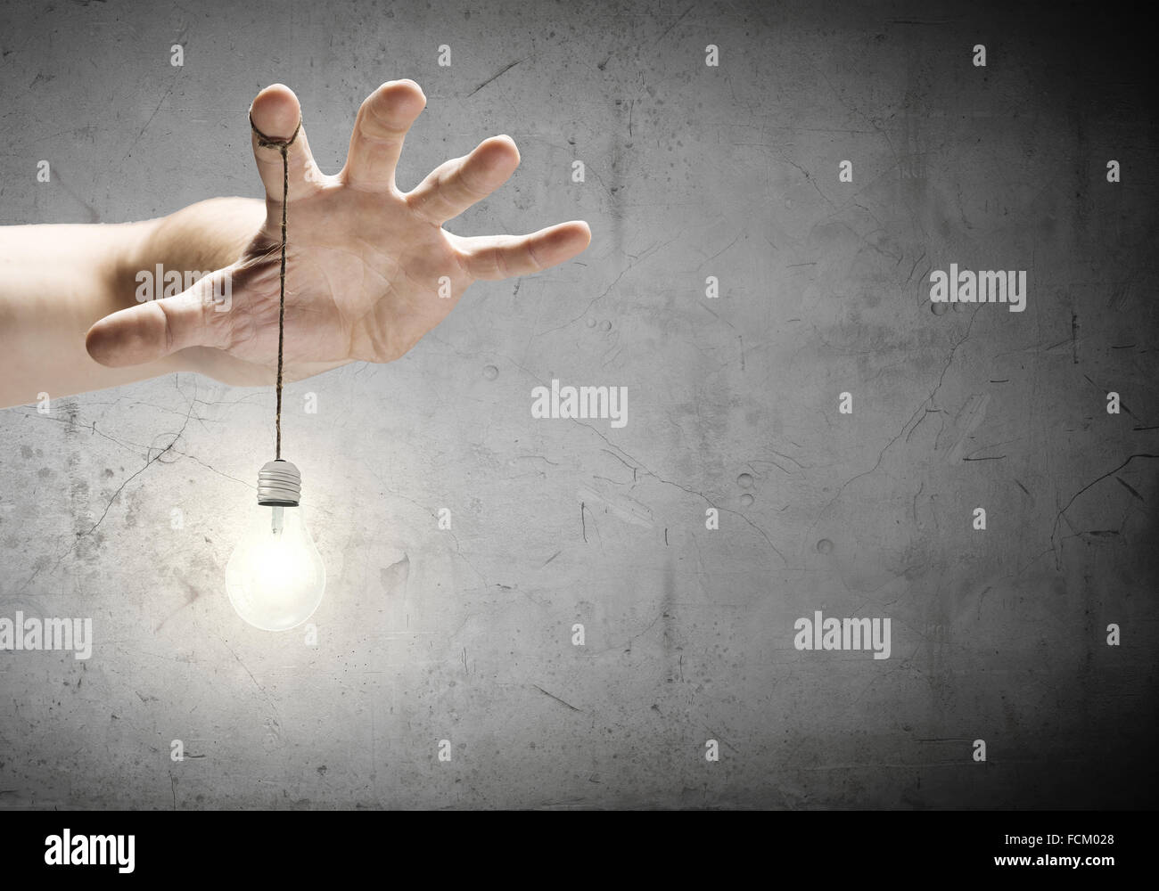 Close up of human hand and light bulb hanging on finger Stock Photo - Alamy