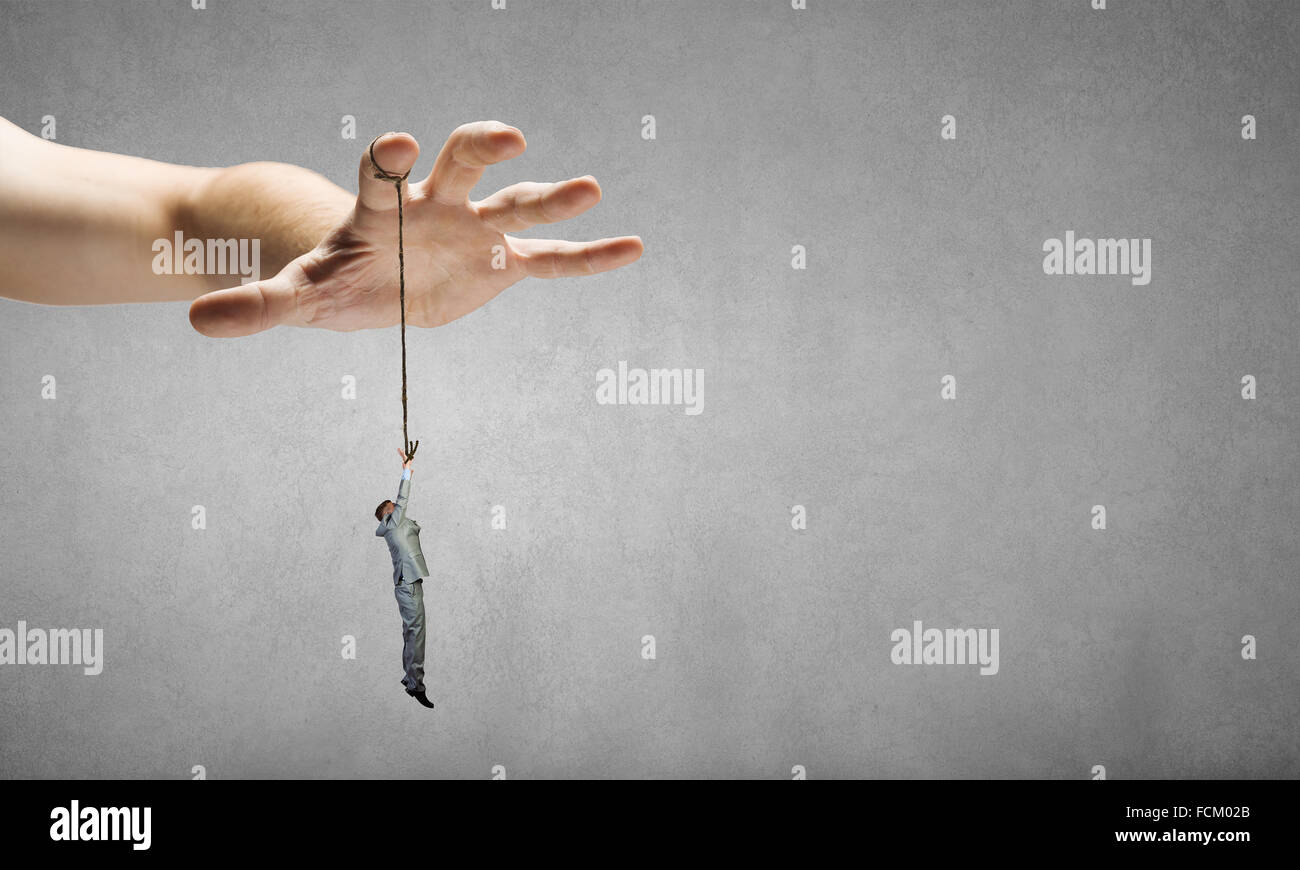 Close up of human hand and people hanging on fingers Stock Photo - Alamy