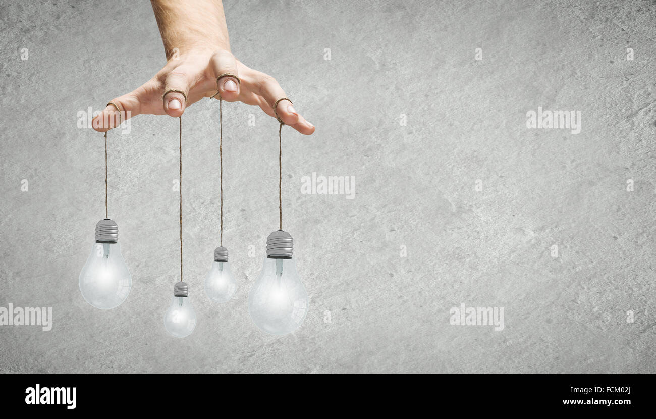 Close up of human hand and light bulbs hanging on finger Stock Photo ...