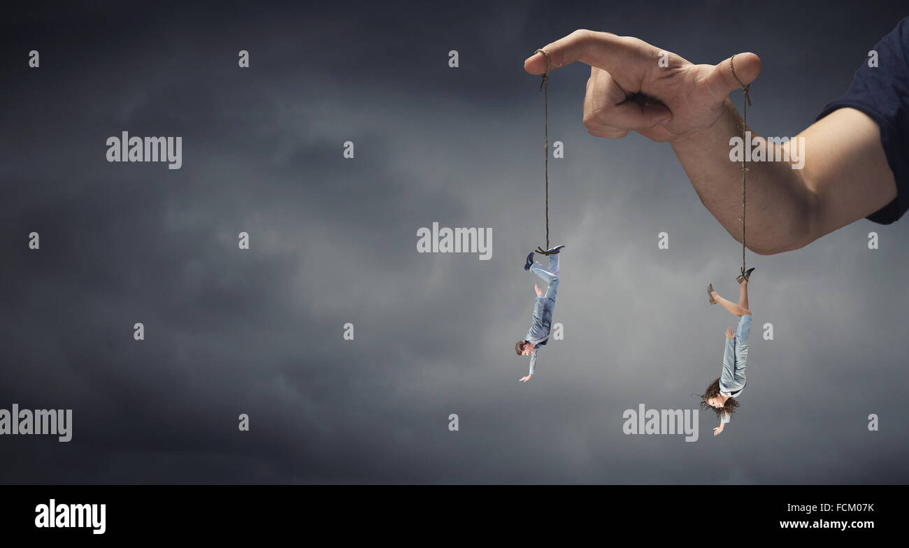 Close up of human hand and people hanging on fingers Stock Photo - Alamy