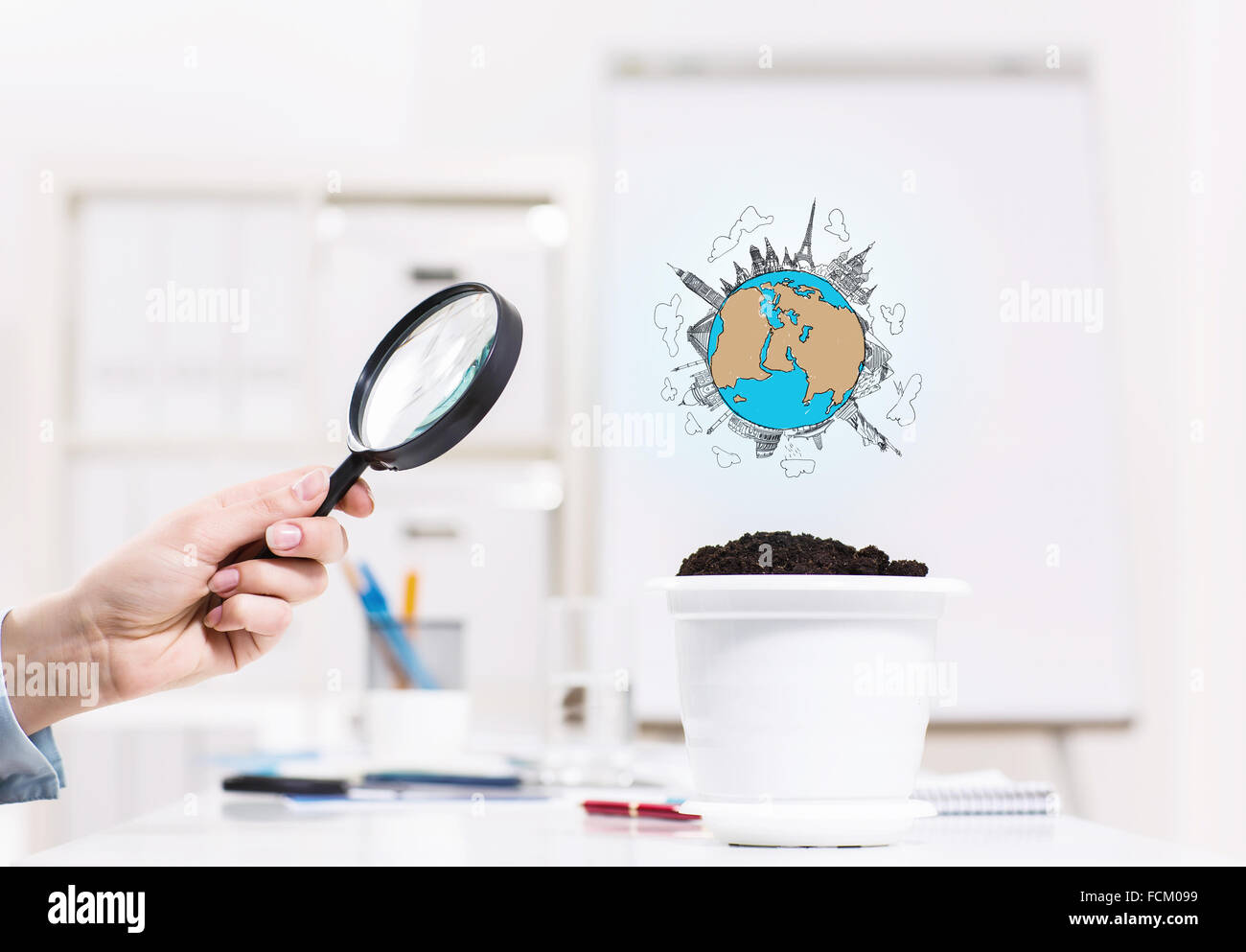 Close up of human hand examining plant in pot with magnifier Stock ...