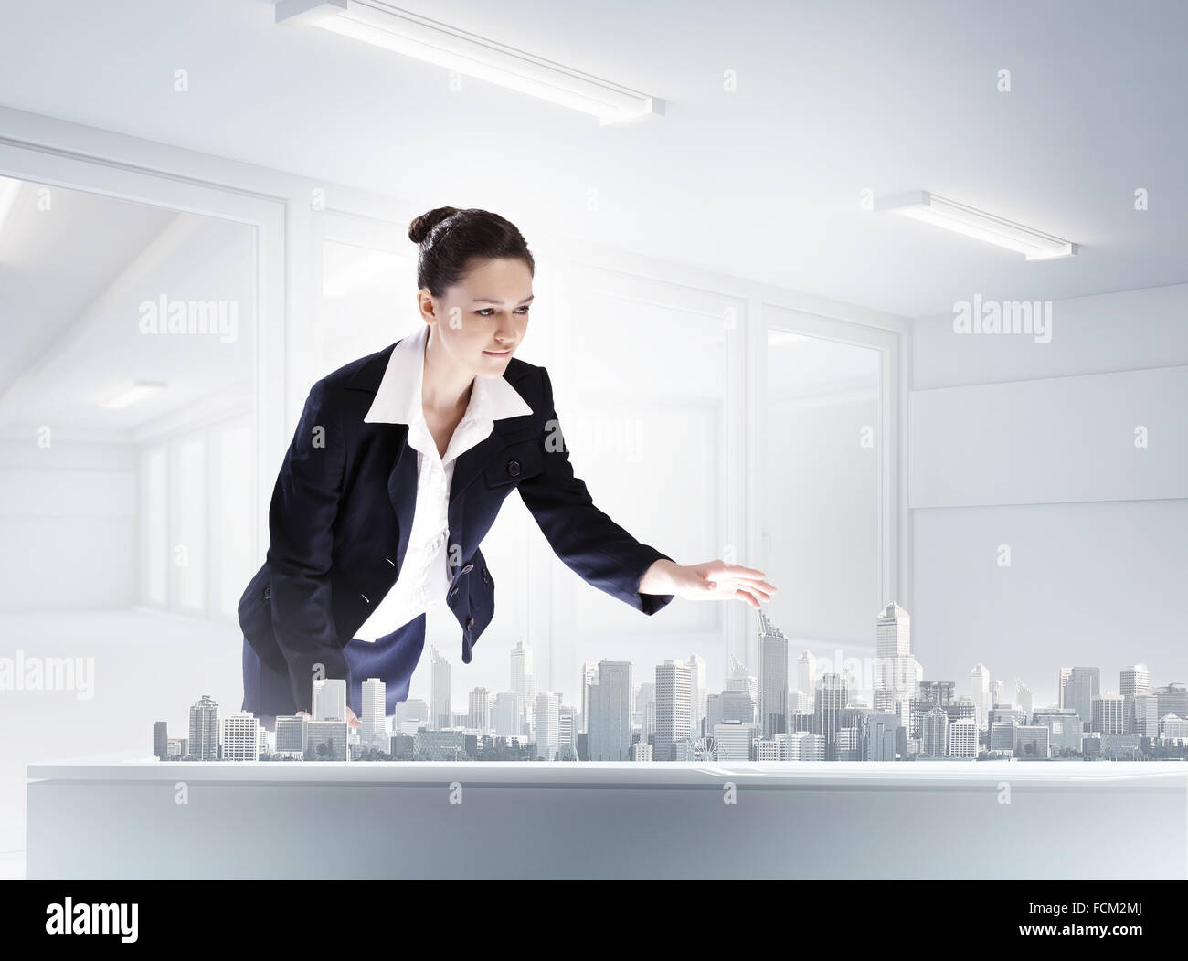 Young businesswoman examining model of construction project hi-res ...