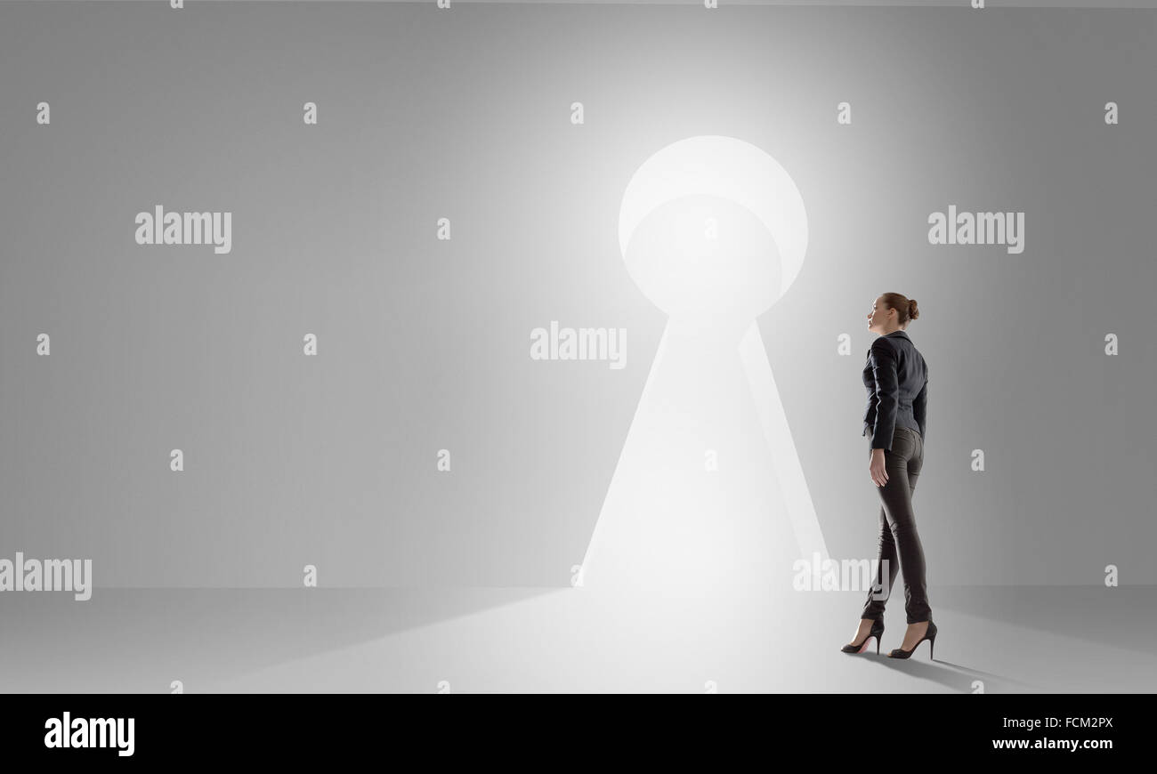 Back view of businesswoman standing in keyhole doorway Stock Photo - Alamy