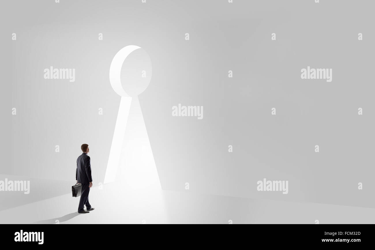 Back view of businessman standing in keyhole doorway Stock Photo - Alamy