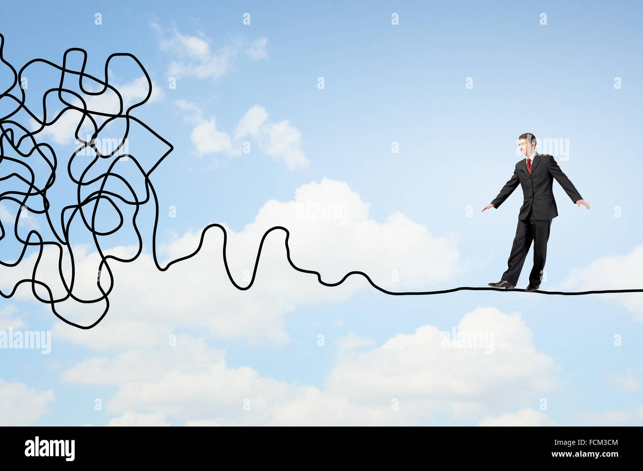 Businessman walking on twisted rope high in sky Stock Photo - Alamy