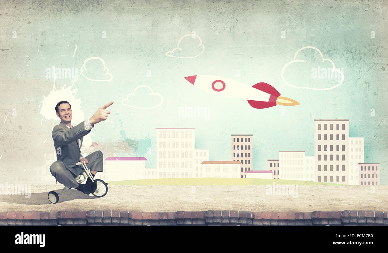 Young handsome businessman riding three wheeled bicycle Stock Photo - Alamy