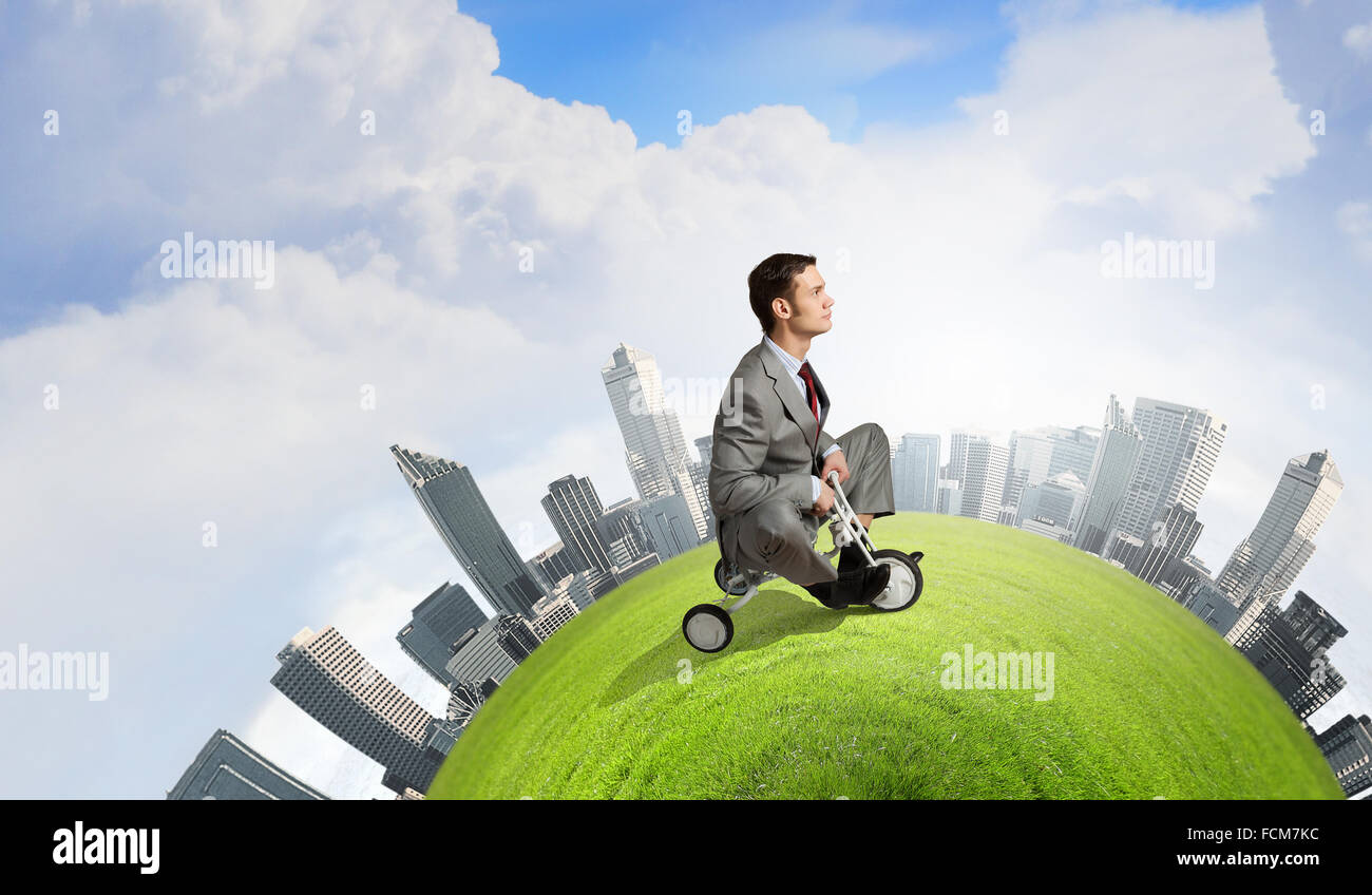 Young handsome businessman riding three wheeled bicycle Stock Photo - Alamy