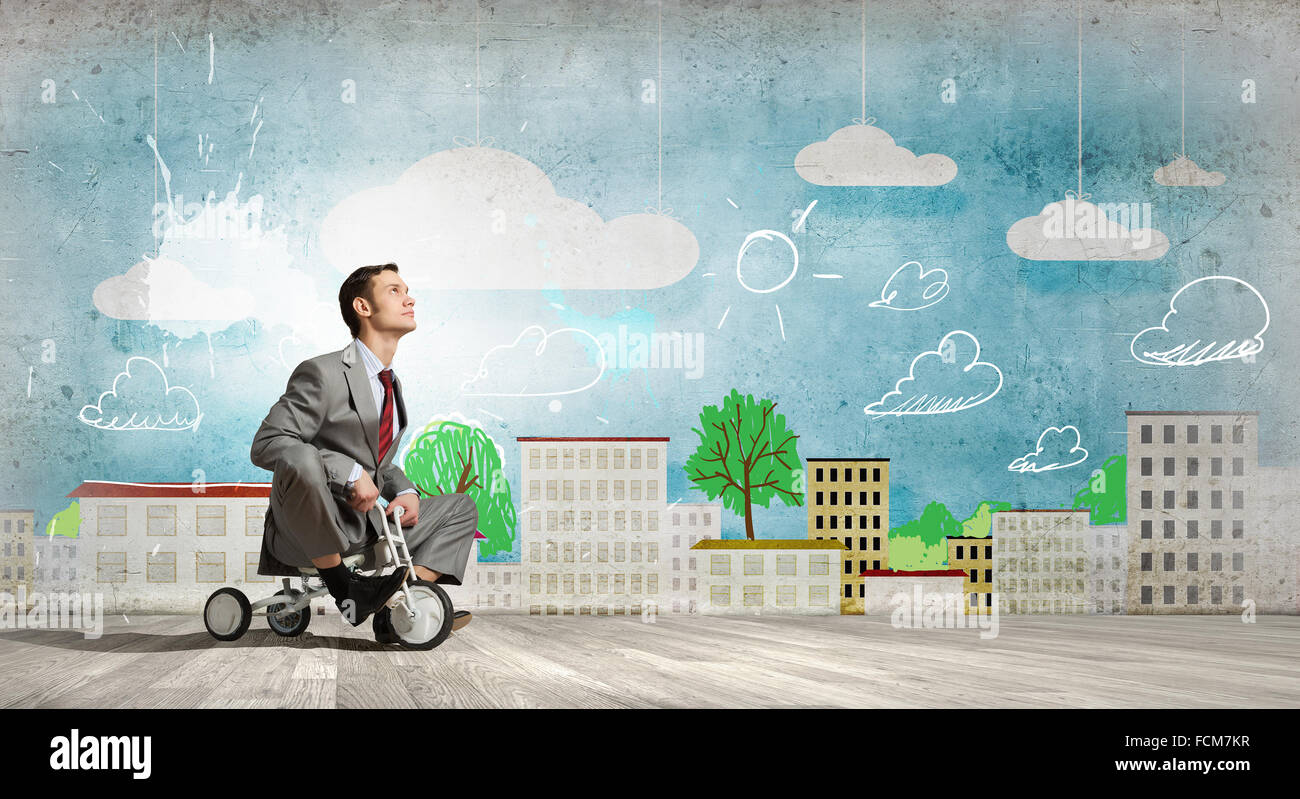 Young handsome businessman riding three wheeled bicycle Stock Photo - Alamy