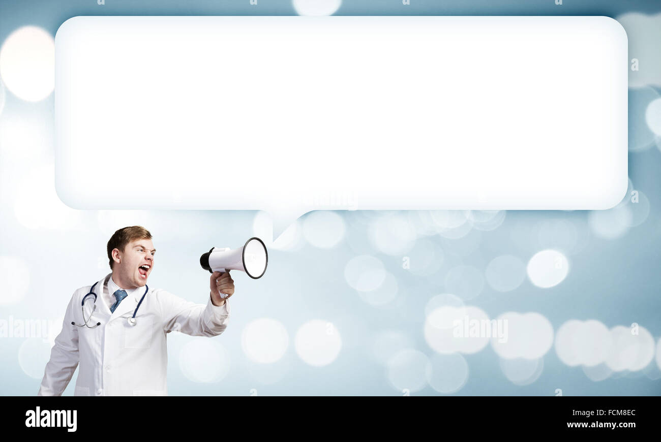 Young male doctor screaming in megaphone emotionally Stock Photo - Alamy