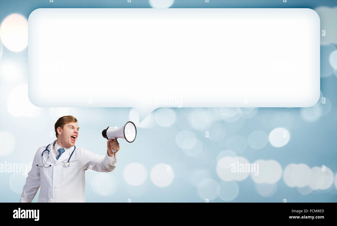Young male doctor screaming in megaphone emotionally Stock Photo - Alamy