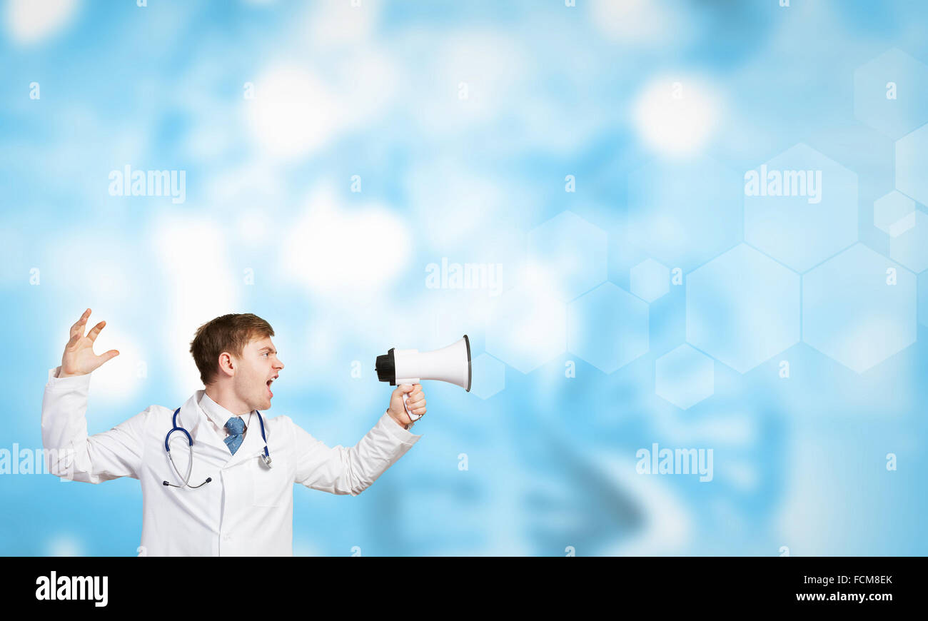 Young male doctor screaming in megaphone emotionally Stock Photo - Alamy