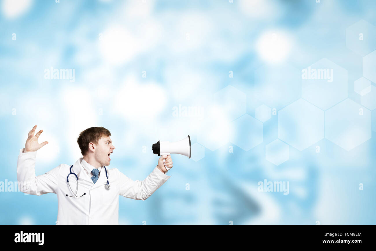Young male doctor screaming in megaphone emotionally Stock Photo - Alamy