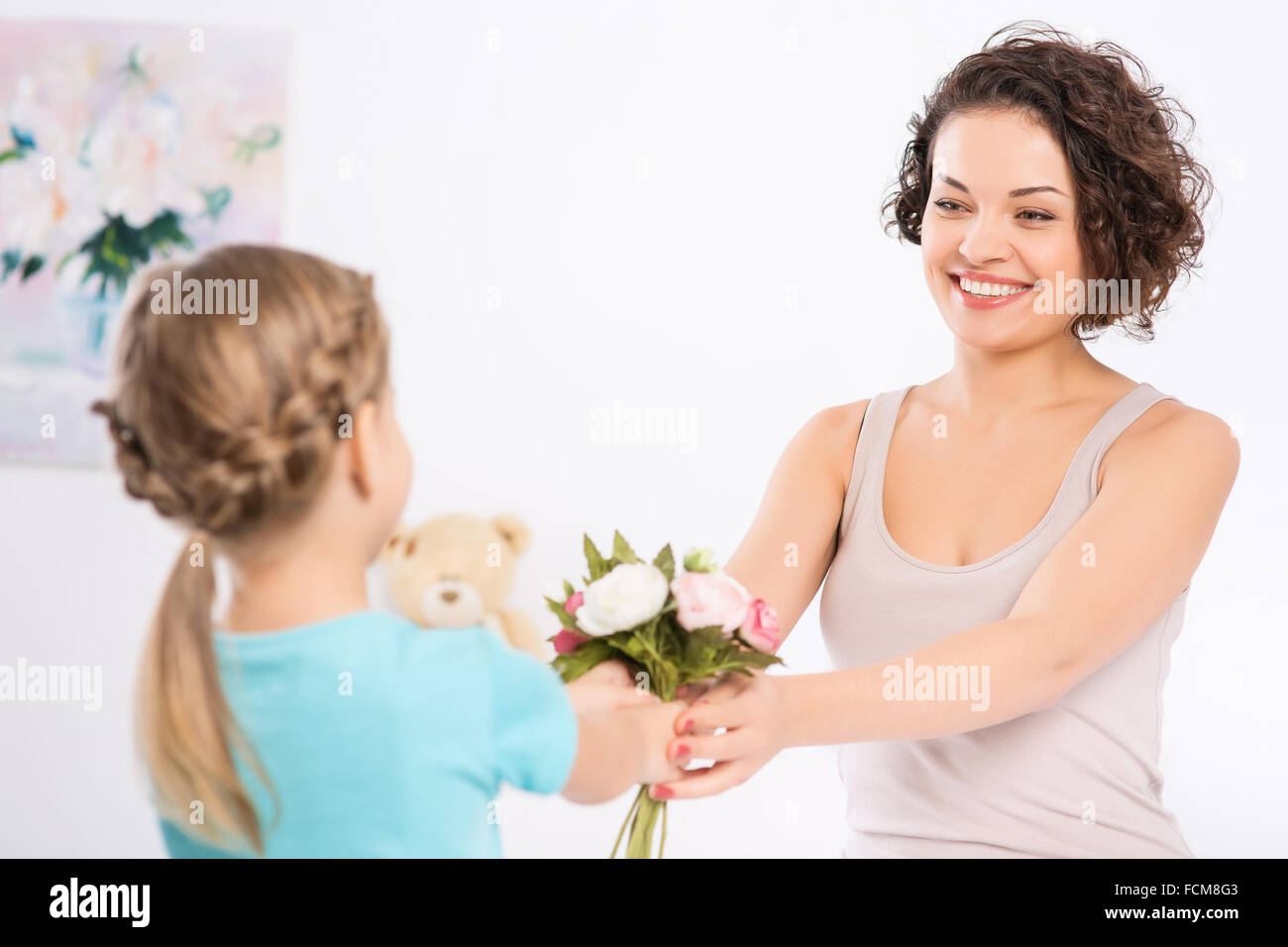 Daughter giving flowers to her mom Stock Photo - Alamy