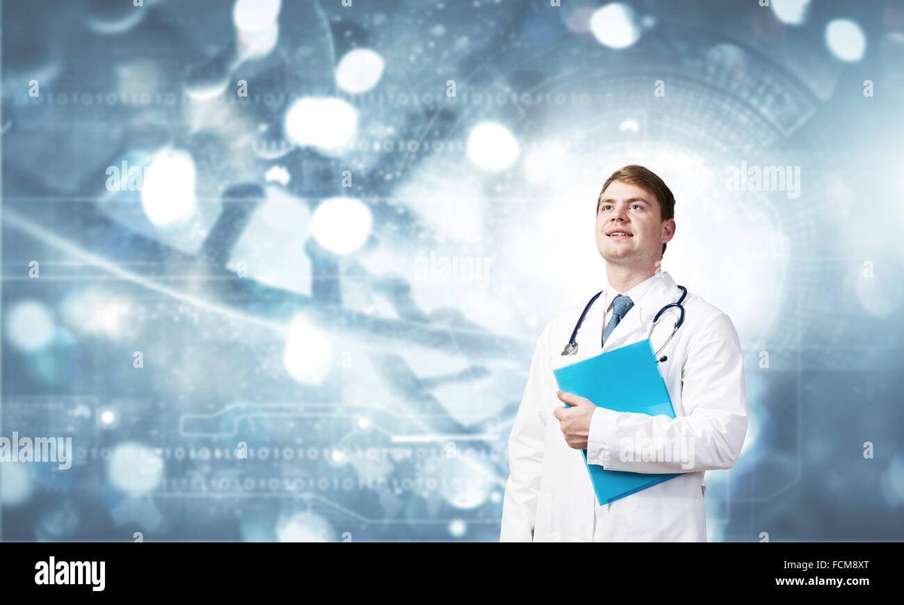 Young man doctor holding folder thinking something over Stock Photo - Alamy