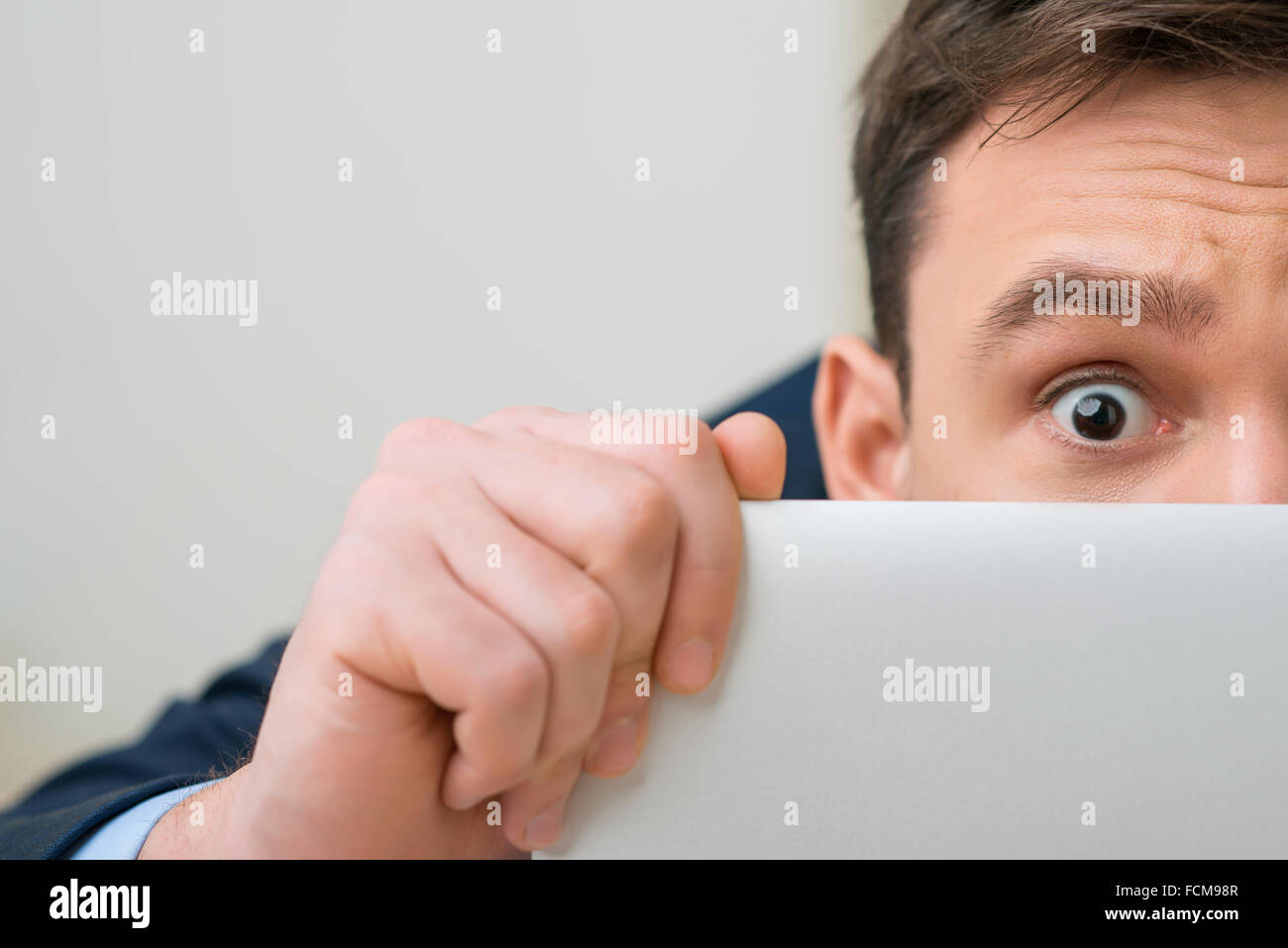 Young Man Hiding Behind Office High Resolution Stock Photography and ...