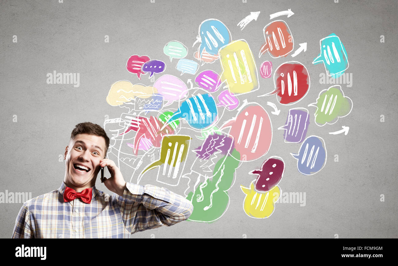 Young man with mobile phone and colorful chat icons Stock Photo - Alamy