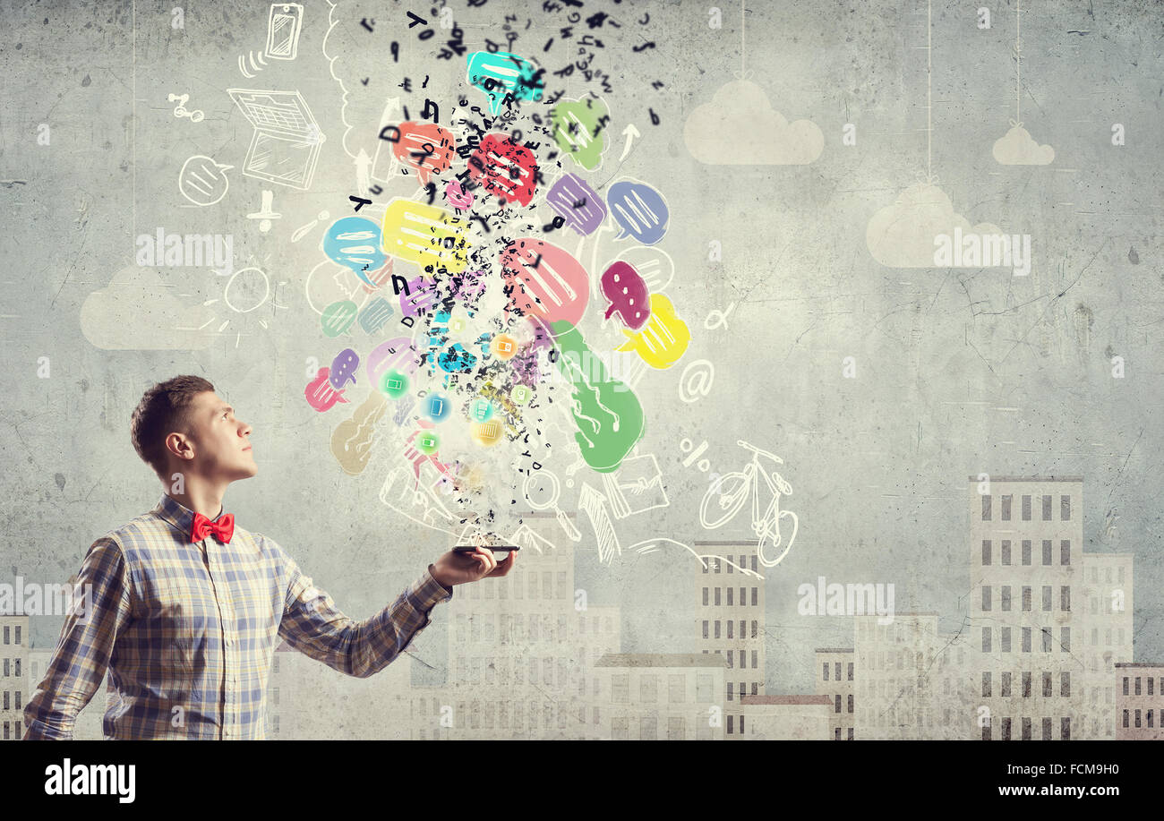 Young man with mobile phone and colorful chat icons Stock Photo - Alamy