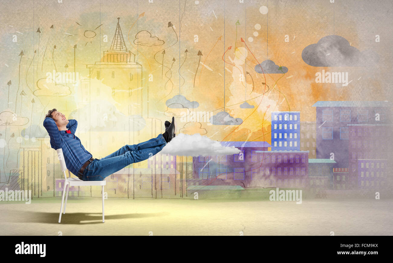 Young man sitting in chair with legs up and relaxing Stock Photo - Alamy
