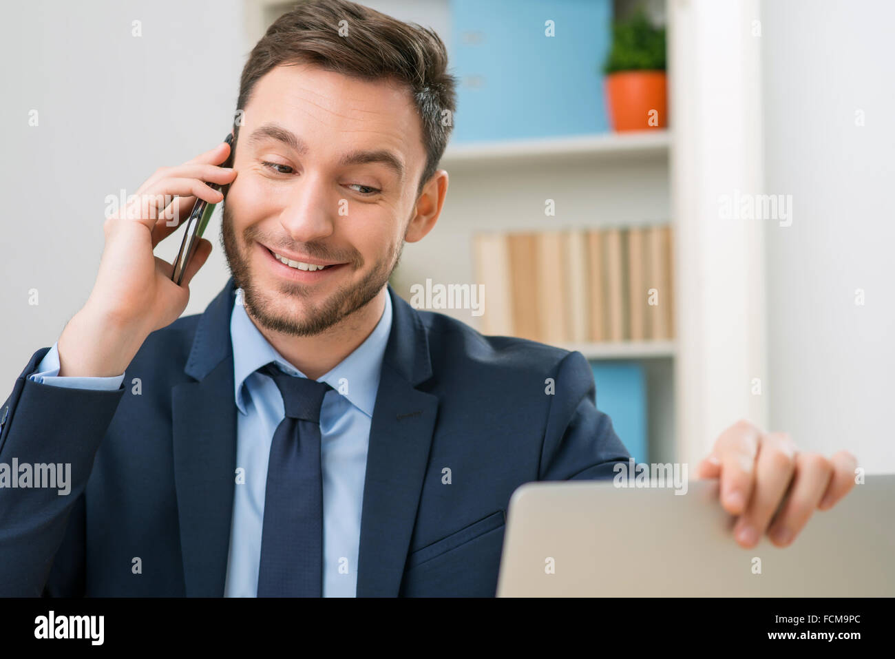 Positive office worker talking on mobile phone Stock Photo - Alamy