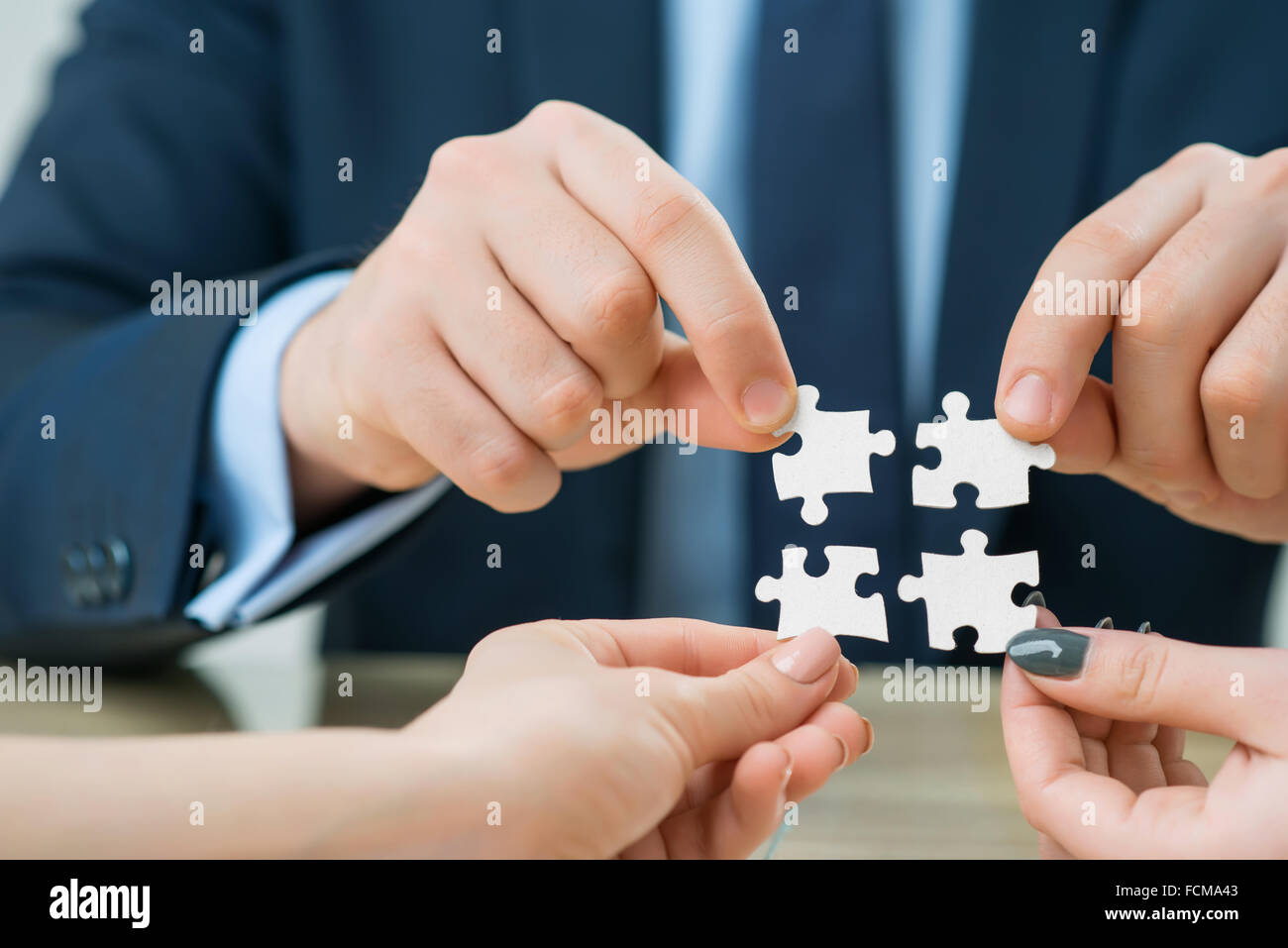 Office workers holding puzzles Stock Photo - Alamy