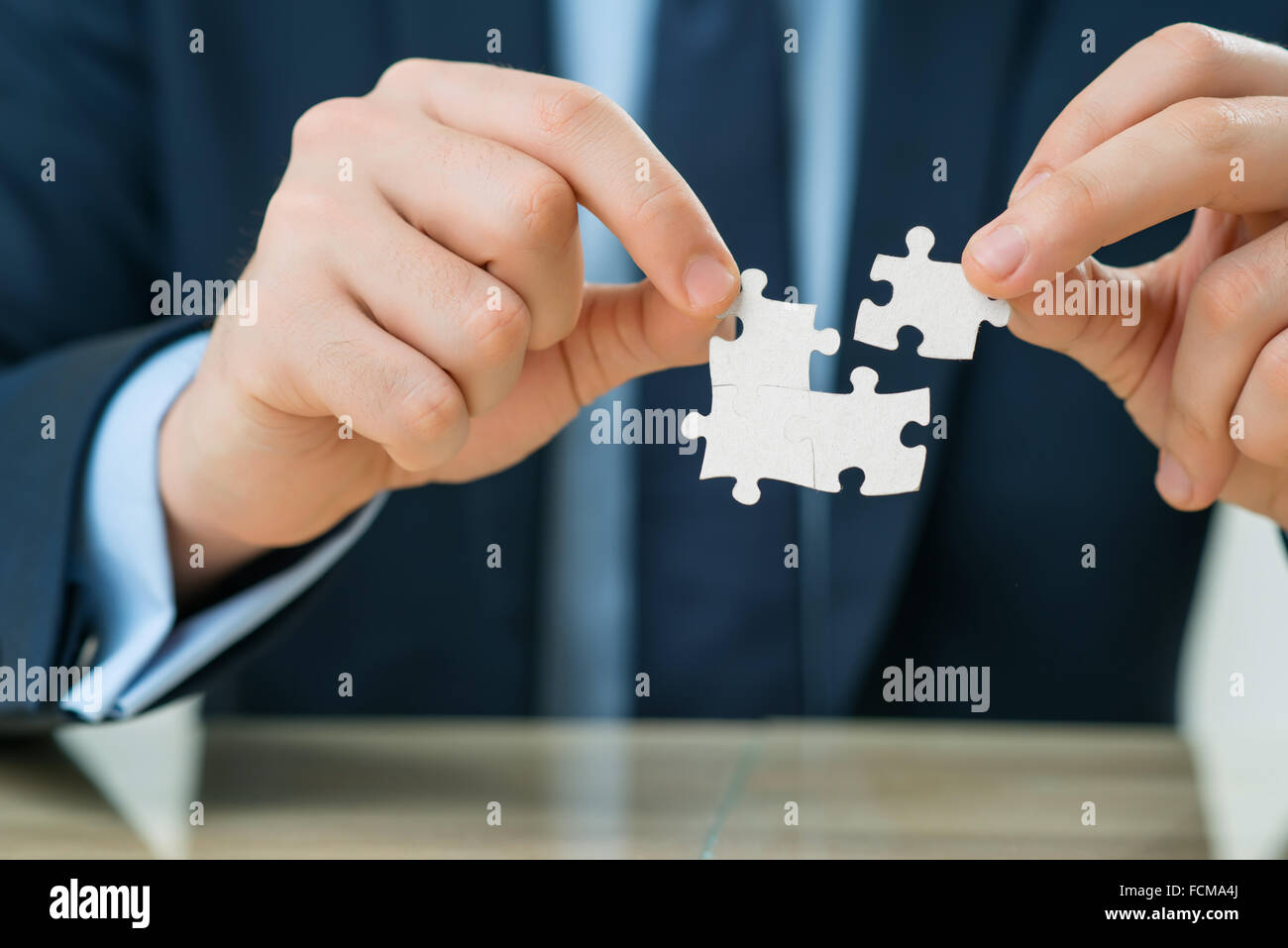 Office workers holding puzzles Stock Photo - Alamy