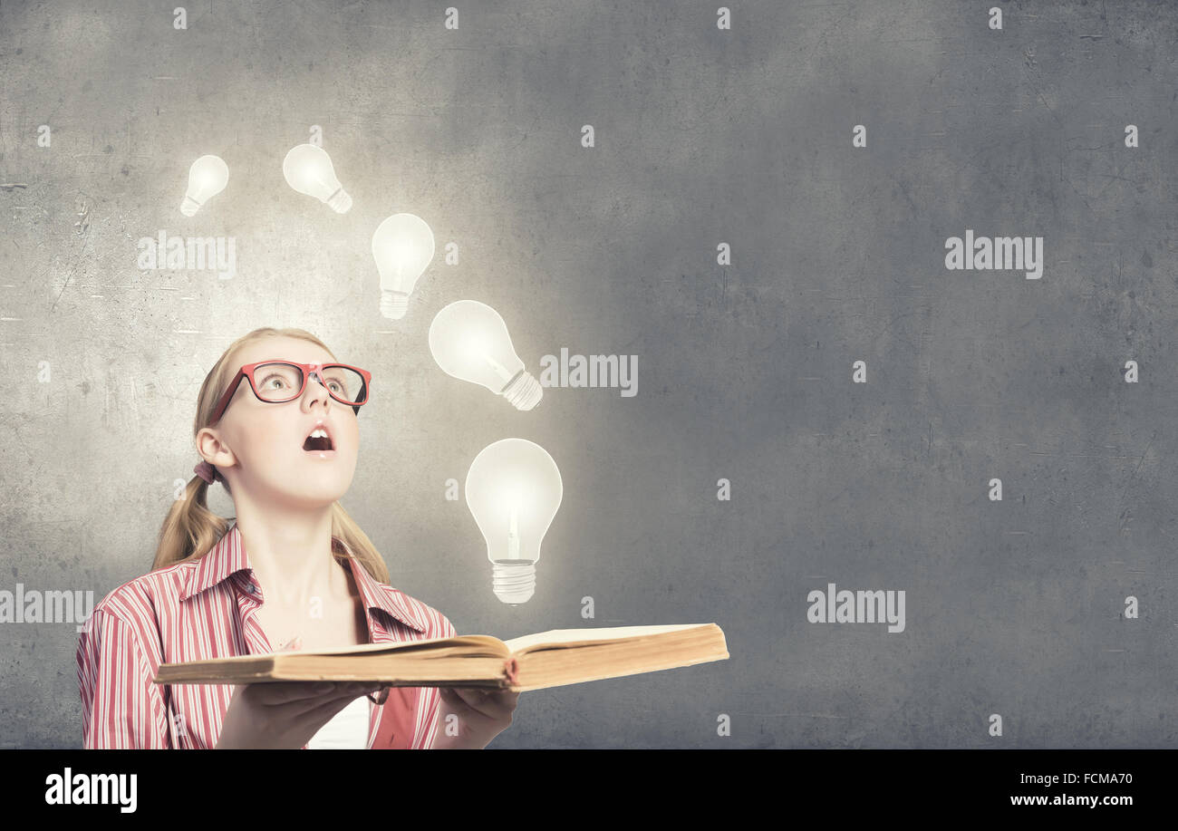 Young funny girl with opened book in hands Stock Photo - Alamy
