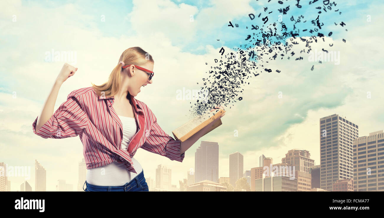 Young funny girl with opened book in hands Stock Photo - Alamy