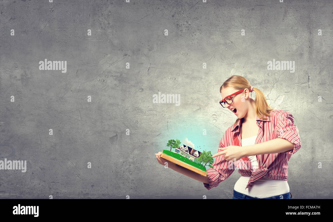 Young funny girl with opened book in hands Stock Photo - Alamy