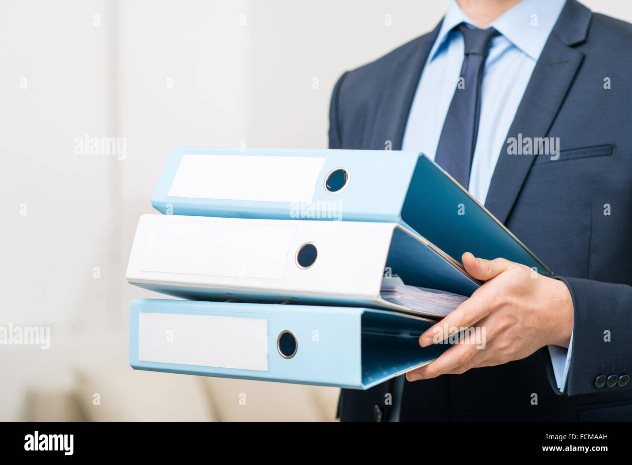 Professional office worker holding folders Stock Photo - Alamy